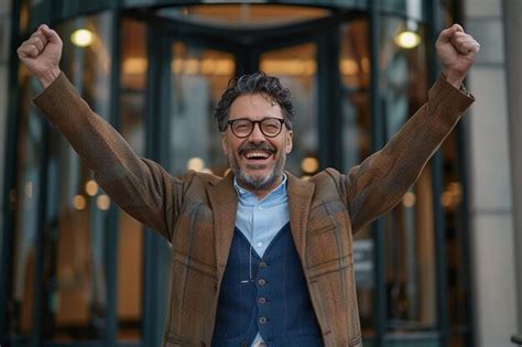 Premium Photo Smiling Man In Suit And Glasses With Arms Up In The Air