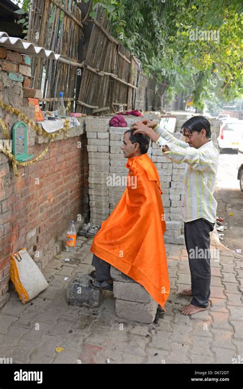 A Barber Giving His Client A Head Massage On A Street Pavement In