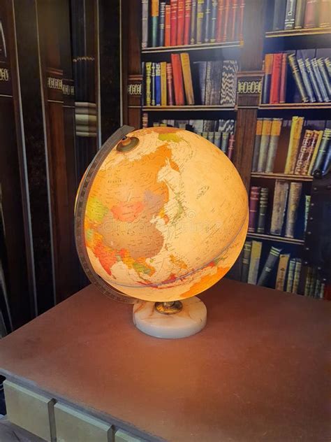 Earth Globe Lamp Lit On A Wooden Table In A Library Editorial Photo