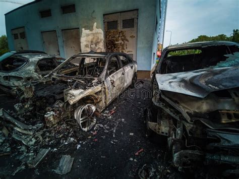 A Cropped Front View Of A Burned And Abandoned Rusty Cars Stock Photo
