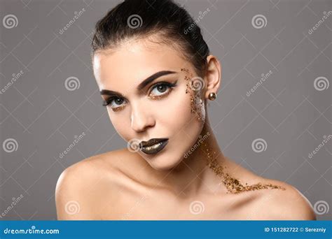 Beautiful Young Woman With Extravagant Makeup On Grey Background Stock