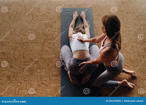 Yoga Exercises A Personal Trainer Teaches A Woman Yoga Classes In The