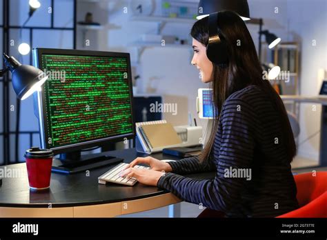 Female Programmer Working With Computer In Office At Night Stock Photo