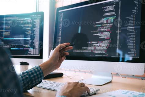 Software Developer Holds The Pen Pointing To The Computer Screen And Is