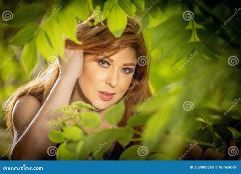 Portrait Of A White Redhead Female Looking Towards The Camera Through