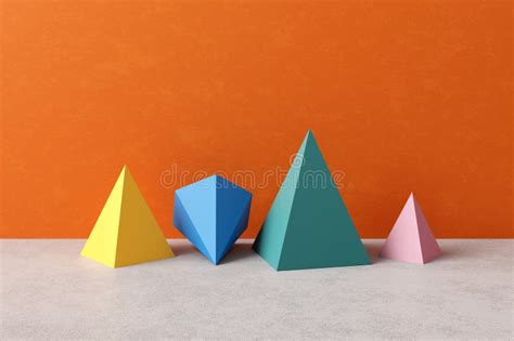 Three Dimensional Prism Pyramid Objects On Blue Colored Background