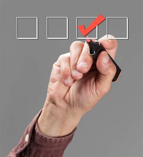 Premium Photo Hand With Pen Mark The Check Boxes