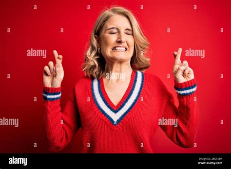 Middle Age Beautiful Blonde Woman Wearing Casual Sweater Over Isolated