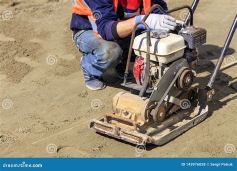 Worker Compacting Sand With Vibrating Plate Tamper Editorial Photo CartoonDealer Com 37988653