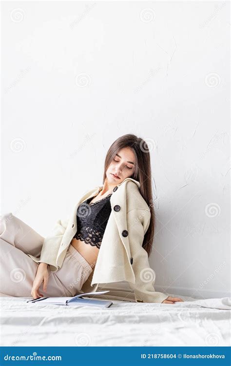 Beautiful Woman In Comfy Home Clothes Writing Notes Sitting On The