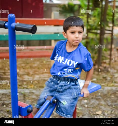 Asian Boy Doing Routine Exercise In Society Park During The Morning