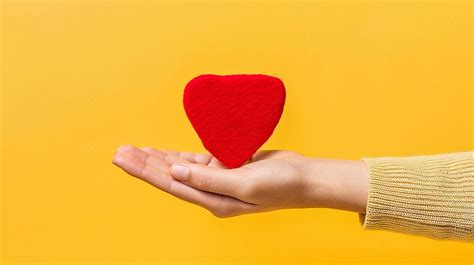 Premium Photo A Woman Holds A Red Heart In Her Hand