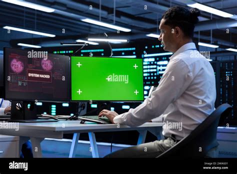 Engineer In Server Hub Using Green Screen Pc To Stop Hacker Passing