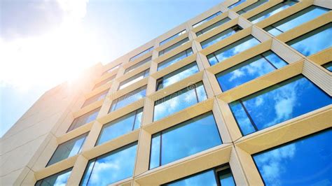 Modern Office Building With Glass Facade On A Clear Sky Background