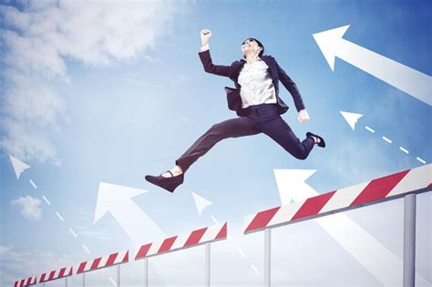 premium photo businesswoman jumping through hurdles with arrows