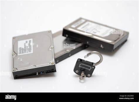 Computer Hard Disks And Open Metal Padlock Symbolizing Concept For