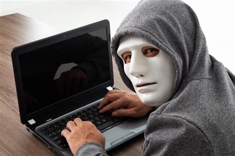 Premium Photo Thief Hacker In Mask Stealing Personal Information From