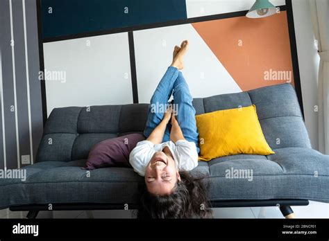 Beautiful Bored Brunette Girl On The Couch In A Stylish Interior Is Watching Tv Switches The Tv