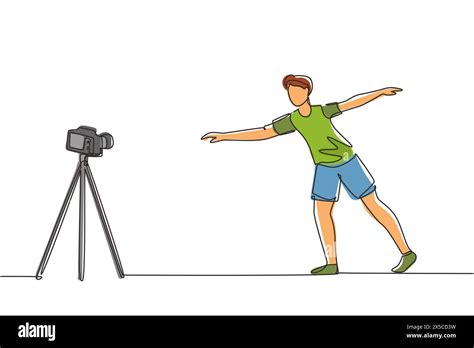 Single One Line Drawing Young Man Doing Exercise On Mat With Camera Shooting Video For Blog On