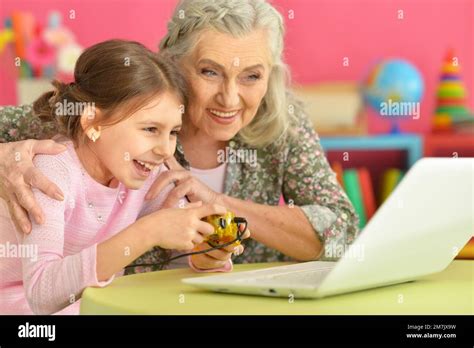 Granny With Her Granddaughter Playing Computer Game Stock Photo Alamy