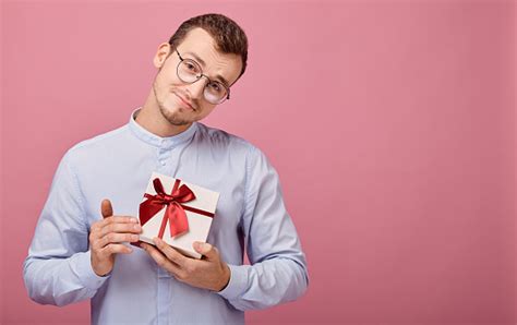 셔츠를 입은 남자가 선물을 상자에 들고 똑바로 보입니다 남자에 대한 스톡 사진 및 기타 이미지 남자 놀라움 동유럽 후예