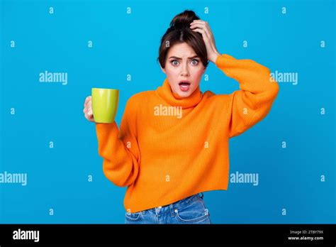 Photo Of Impressed Shocked Woman Dressed Orange Sweater Drinking Tea