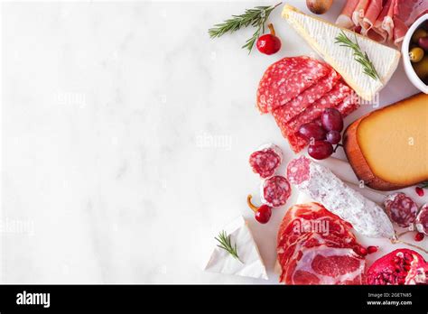 Selection Of Cheese And Meat Appetizers Above View Side Border On A