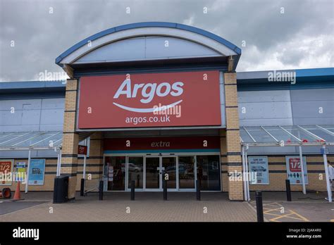 Argos store entrance. Big red and white sign over glass doors. Argos is ...