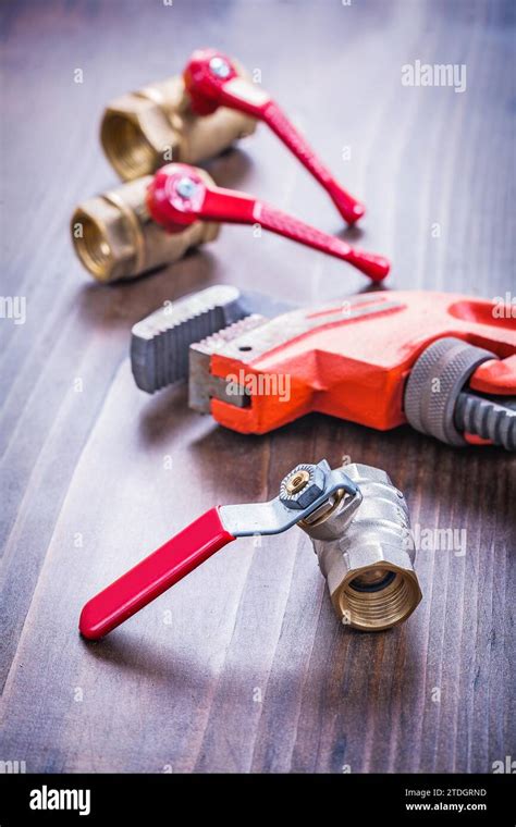 Adjustable Spanner And Sanitary Fittings On An Old Wooden Board Stock