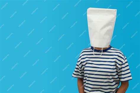 Premium Photo Woman With White Paper Bag On Head On Blue Background Space For Text