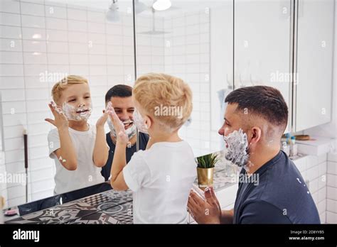 Father With His Son Is In The Bathroom Have Fun By Using Shaving Gel