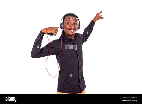 A Student In A Shirt Standing On White Background Listening To Music