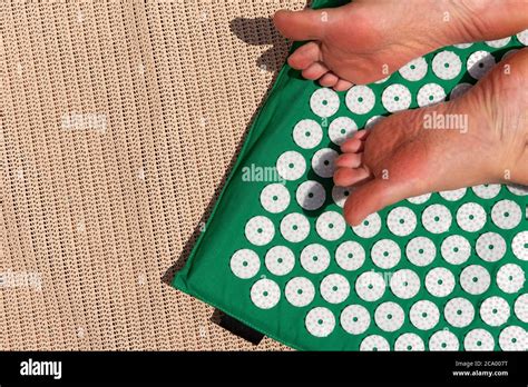 Female Feet Standing On Acupressure Mat Self Acupuncture Massage Home