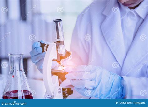 Female Scientist Look At Microscope Science Test Tube Analyse Scientific Sample In Laboratory