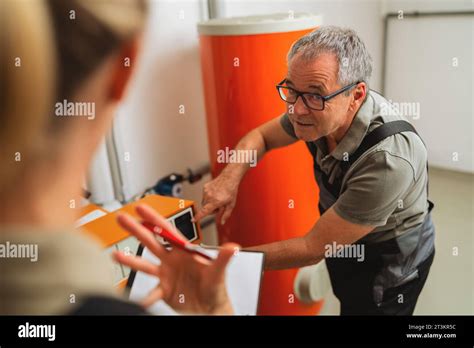 Team Of Heating Engineers Checks A Old Gas Heating System At A Boiler Room In A House Gas