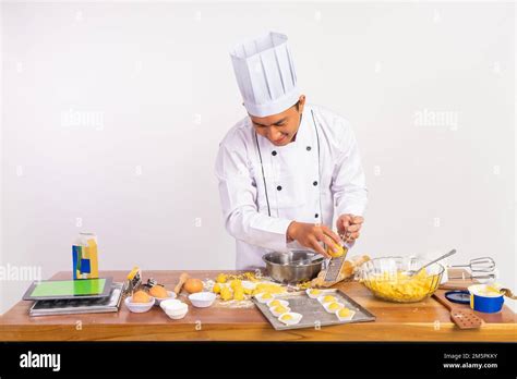 Male Chef Using Grater While Grating Cheese Onto Cake Stock Photo Alamy