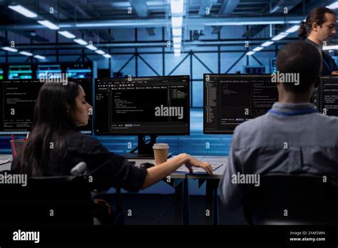 Person With Paraplegia And Colleague Working In Inclusive Server Farm Facility Doing