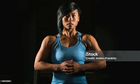 Confident Female Bodybuilder Flexing Muscles In Gym Portrait Stock