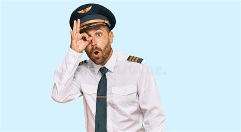 Handsome Man With Beard Wearing Airplane Pilot Uniform Doing Ok Gesture