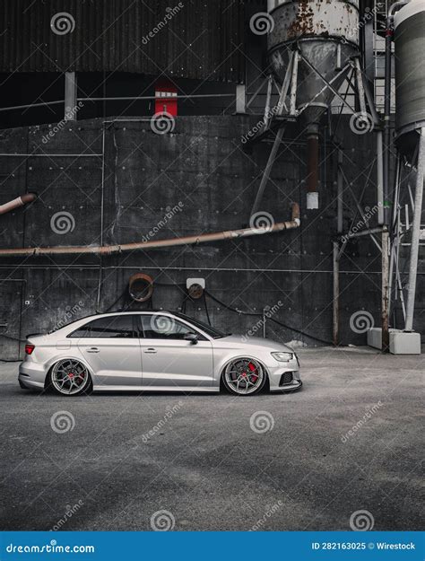 Audi Rs5 Luxury Car Parked In Front Of An Industrial Style Building