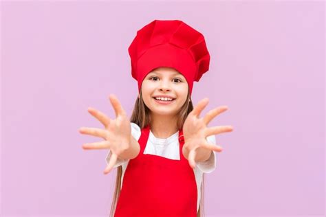 Premium Photo A Teenage Girl In A Chefs Costume Is Very Surprised