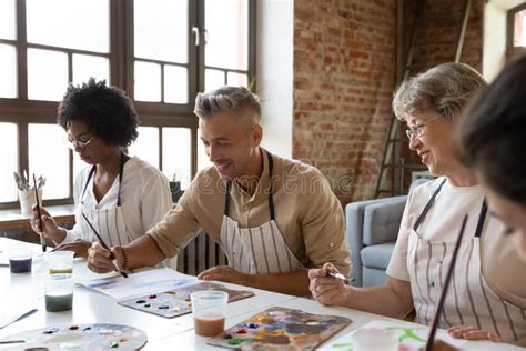 Happy Handsome Man Enjoying Drawing Workshop With Diverse People Stock