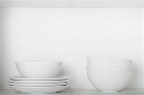 Premium Photo White Plates And Bowls On A Shelf In The Cupboard