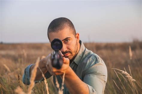 Premium Photo Killer Aim In The Field With A Sniper Rifle