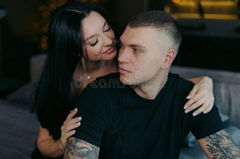 A Man And Woman Sitting On A Bed Young Beautiful Couple Hugging Stock Image Image Of Cozy