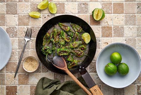 Cooking Padron Peppers By Stocksy Contributor Darren Muir Stocksy