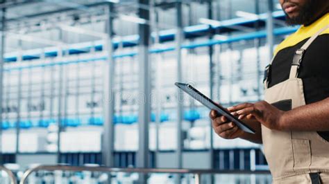Smart Factory Expert Using Digital Device App To Test Automated Systems
