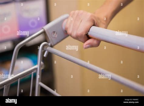 Hand Of Woman Putting On Trolley Stock Photo Alamy