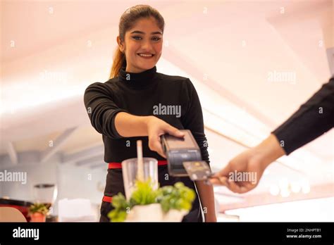 Waitress Holding Card Reader While Customer Making Payment Through