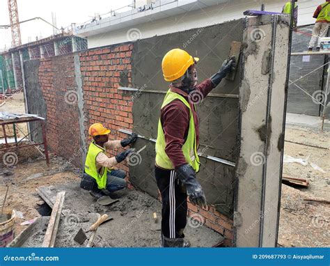 Plastering Work By Construction Workers Using The Cement Plaster